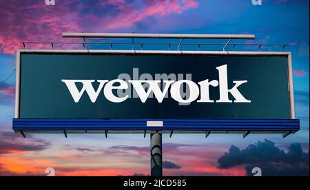 Advertisement billboard displaying logo of WeWork Stock Photo - Alamy