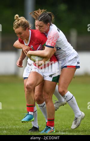 Bethan Dainton of Wales RL, try to break through the England defence ...