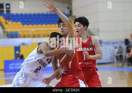 Kei Rooney (R) of Japan Basketball team and Jared Bahay (L) of the Philippine Basketball team in ...