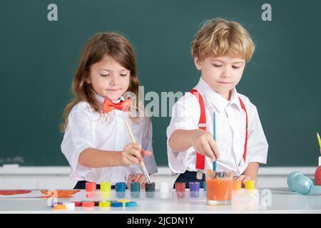 Portrait school kids doing art homework. Children drawing on elementary ...