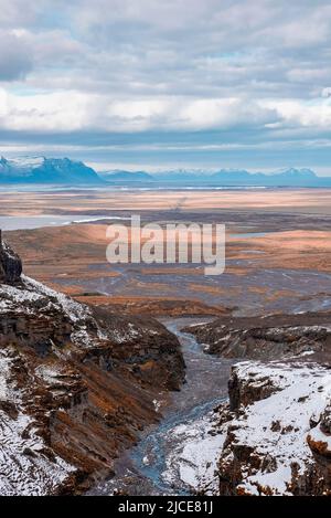 Beautiful view of stream amidst snow covered mountains in valley ...