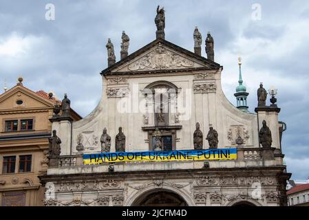 Banner with the inscription Hands of Ukraine, Putin! on the facade of a ...