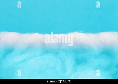 Soft gentle background from white cotton wool and blue paper.Conceptual ...