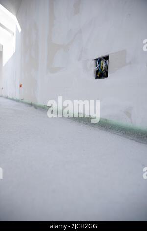 freshly cured concrete screed on construction site in loft in a family ...