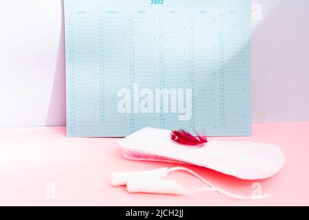 Menstrual pad with schedule card background Stock Photo - Alamy