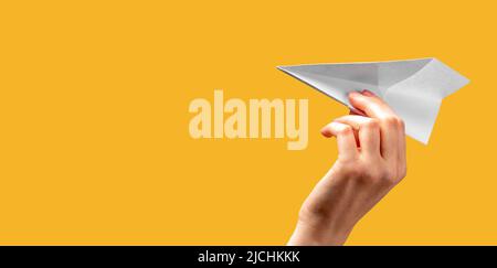 Woman with orange paper plane on color background Stock Photo - Alamy