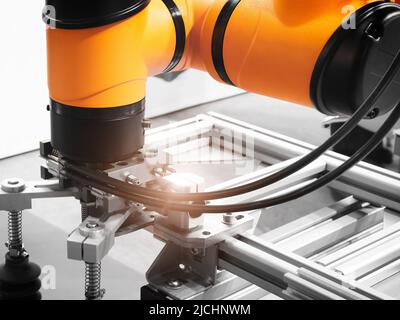Process of automatic loading detail into CNC lathe machine with the robot arm. Selective focus ...