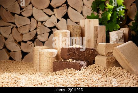 Woodpile with biomass briquettes and pellets in sunlight Stock Photo ...