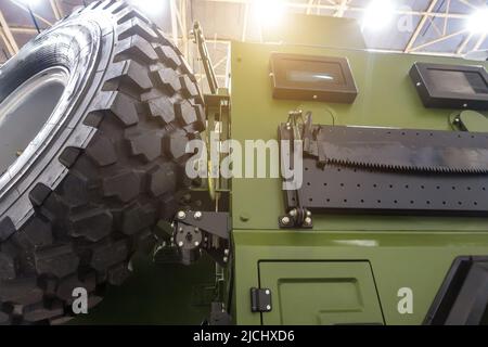 Side window of an armored military truck with a rearview mirror and a ...