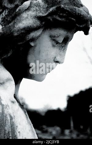 Cemetery statues edited in black and white Stock Photo - Alamy