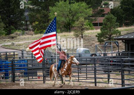 Rodeo in Colorado Springs, Colorado starts with the National Anthem and ...