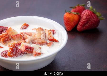 Fresh strawberries with heavy cream and a sprinkle of sugar as a snack ...