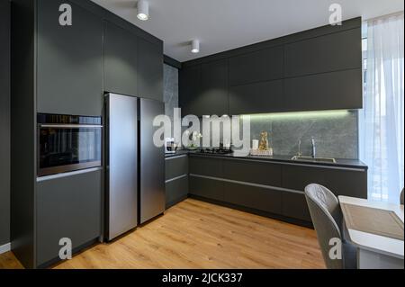 Modern large luxury dark gray kitchen closeup Stock Photo - Alamy