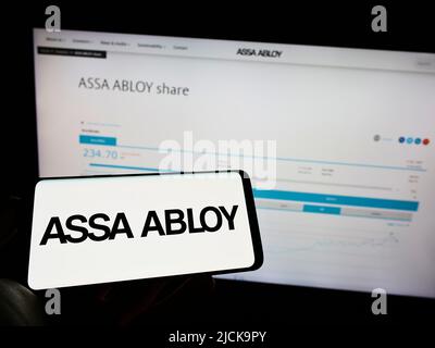 Assa Abloy company logo on a website with blurry stock market ...