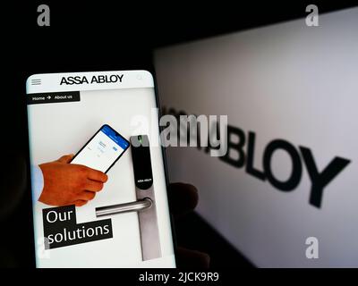 Assa Abloy company logo on a website with blurry stock market ...