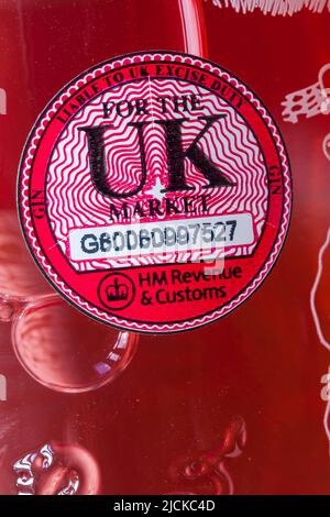 HM Revenue & Customs liable to UK excise duty label printed on a bottle ...