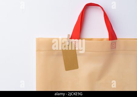 Blank paper tag with shopper paperbag on white background Stock Photo ...