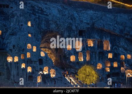 Luoyang longmen grottoes with light at night Stock Photo - Alamy