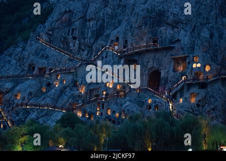 Luoyang longmen grottoes with light at night Stock Photo - Alamy