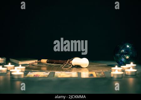 Tarot cards on table near burning candles.Tarot cards spread on table ...