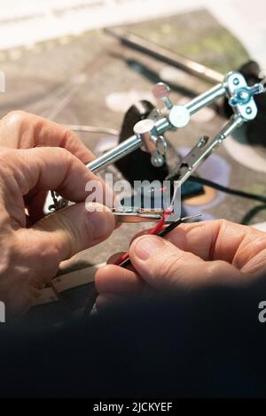 Closeup of macro of a man doing electricity work or putting wires ...