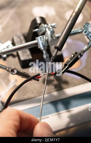 Closeup of macro of a man doing electricity work or putting wires ...