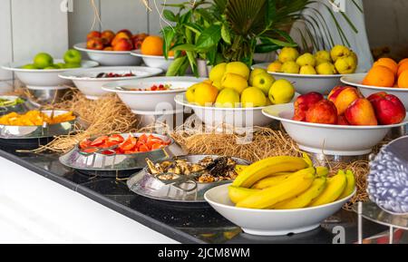 Assortment of different kind of fresh apples on the table in buffet ...