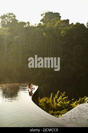 Female guest in two-tier infinity pool at Ubud Hanging Gardens, Bali ...