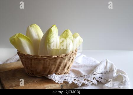 Group of raw endives on a wooden background Stock Photo - Alamy