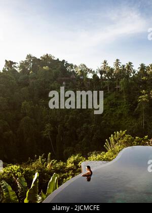 Female guest in two-tier infinity pool at Ubud Hanging Gardens, Bali ...