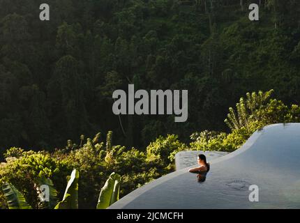 Female guest in two-tier infinity pool at Ubud Hanging Gardens, Bali ...