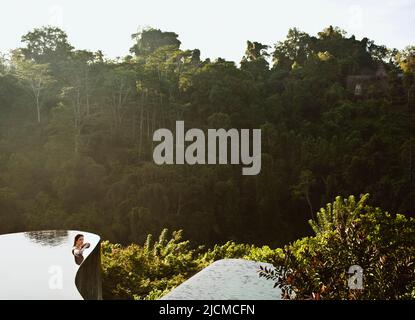 Female guest in two-tier infinity pool at Ubud Hanging Gardens, Bali ...