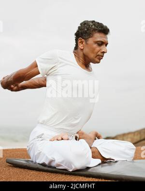 Sri Lankan yoga master practicing forward bends, in psychic union pose ...