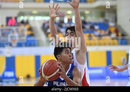 Kei Rooney (R) of Japan Basketball team and Jared Bahay (L) of the Philippine Basketball team in ...