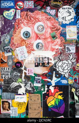 Layers of street art posters and stickers on Brick Lane in London ...