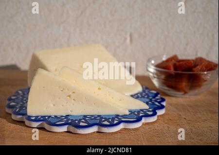 Spanish hard goat cheese served outdoor with membrillo jam and glass of ...