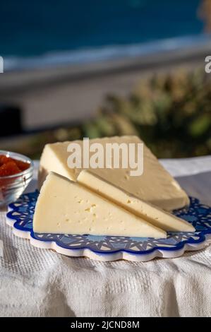 Spanish hard goat cheese served outdoor with membrillo jam and glass of ...