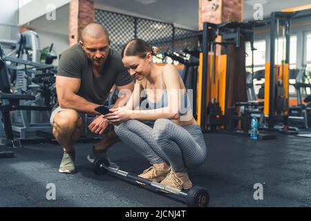 Muscular young man standing reading book with surprised expression ...