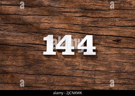Number 144 in wood, isolated on white background Stock Photo - Alamy