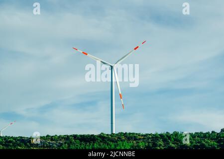 Wind farm with several wind turbines generating energy on the hill ...