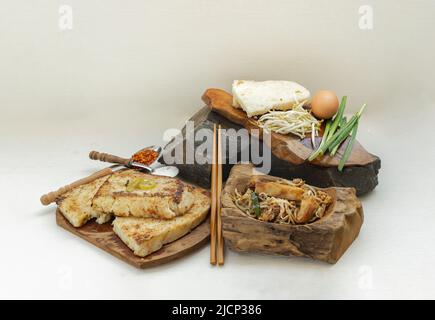 Stir-fried soft turnip cake or Fried radish cake (chai tow kway) with ...