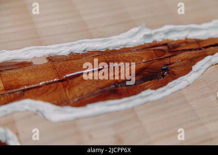 Closeup of dried epoxy resin in wood table. Process of making a craft ...