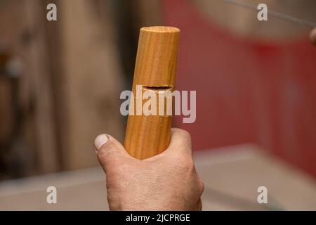 Closeup of carpenter cutting table leg with hand saw Stock Photo - Alamy