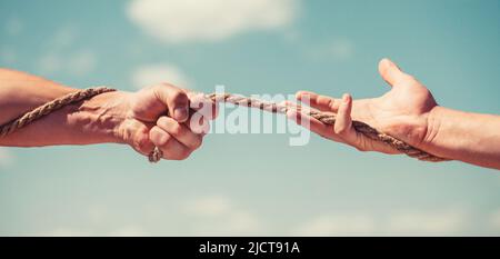 two hands pulling a rope. Rescue, help, helping gesture or hands. Conflict tug of war Stock ...