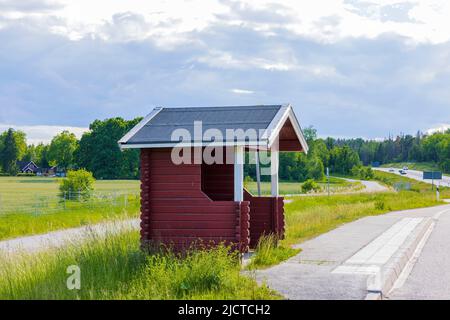 Beautiful view of standard bus stop near park with forest trees in ...