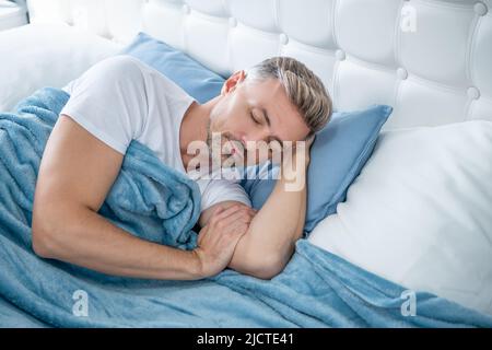grizzled man sleeping in bed. early morning Stock Photo - Alamy