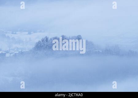 Brianza covered in fresh snow and fog in the early morning, near the ...