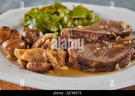 Roast beef with chestnuts and forest mushrooms and green peas. French ...