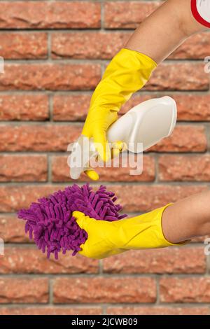 Hands in yellow protective gloves hold chemical flasks. Scientist ...