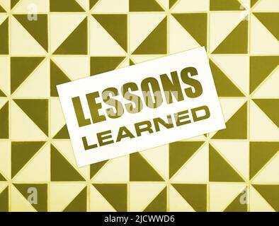 blank card with text Lessons learned on wooden background. Business ...